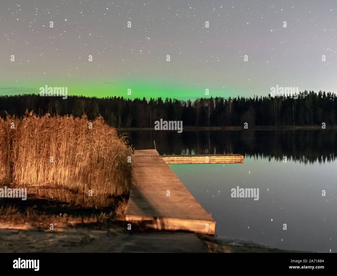 landscape with a beautiful colorful night sky and stars, reflection on ...