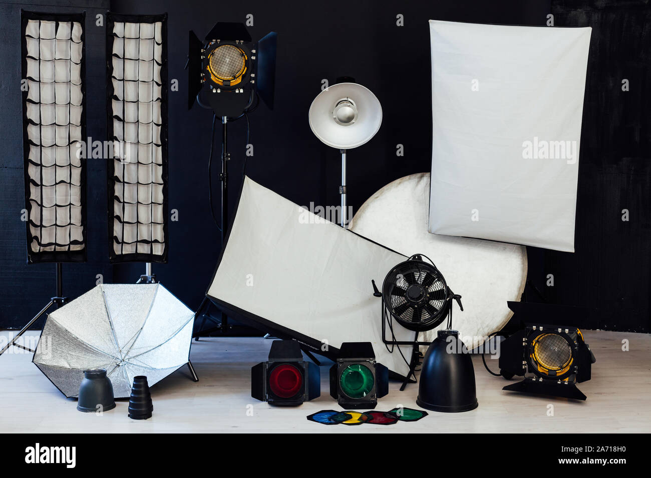 Photo studio equipment flash accessories photographer on black ...
