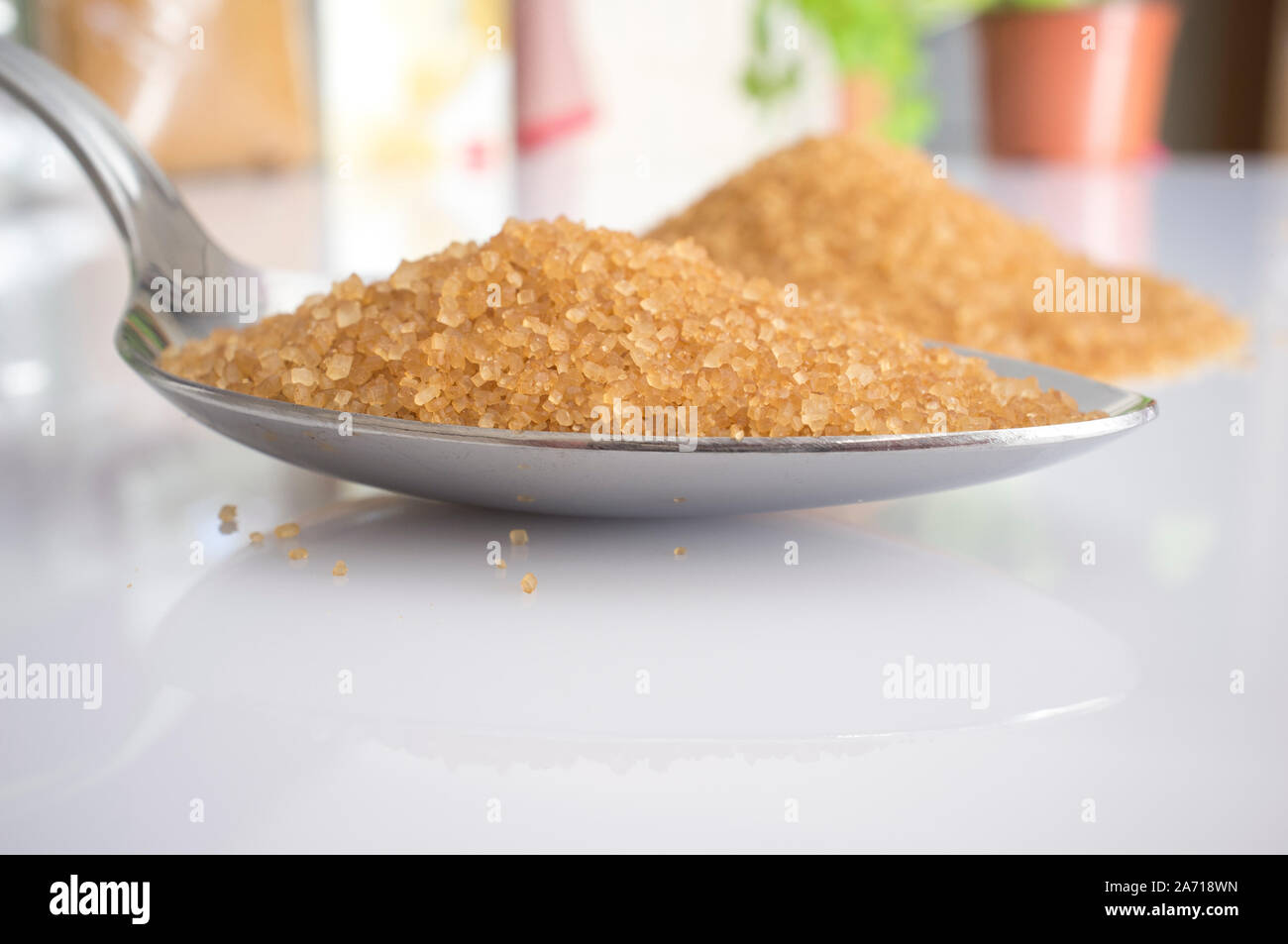 Spoon and heap of brown sugar. Close-up Stock Photo - Alamy