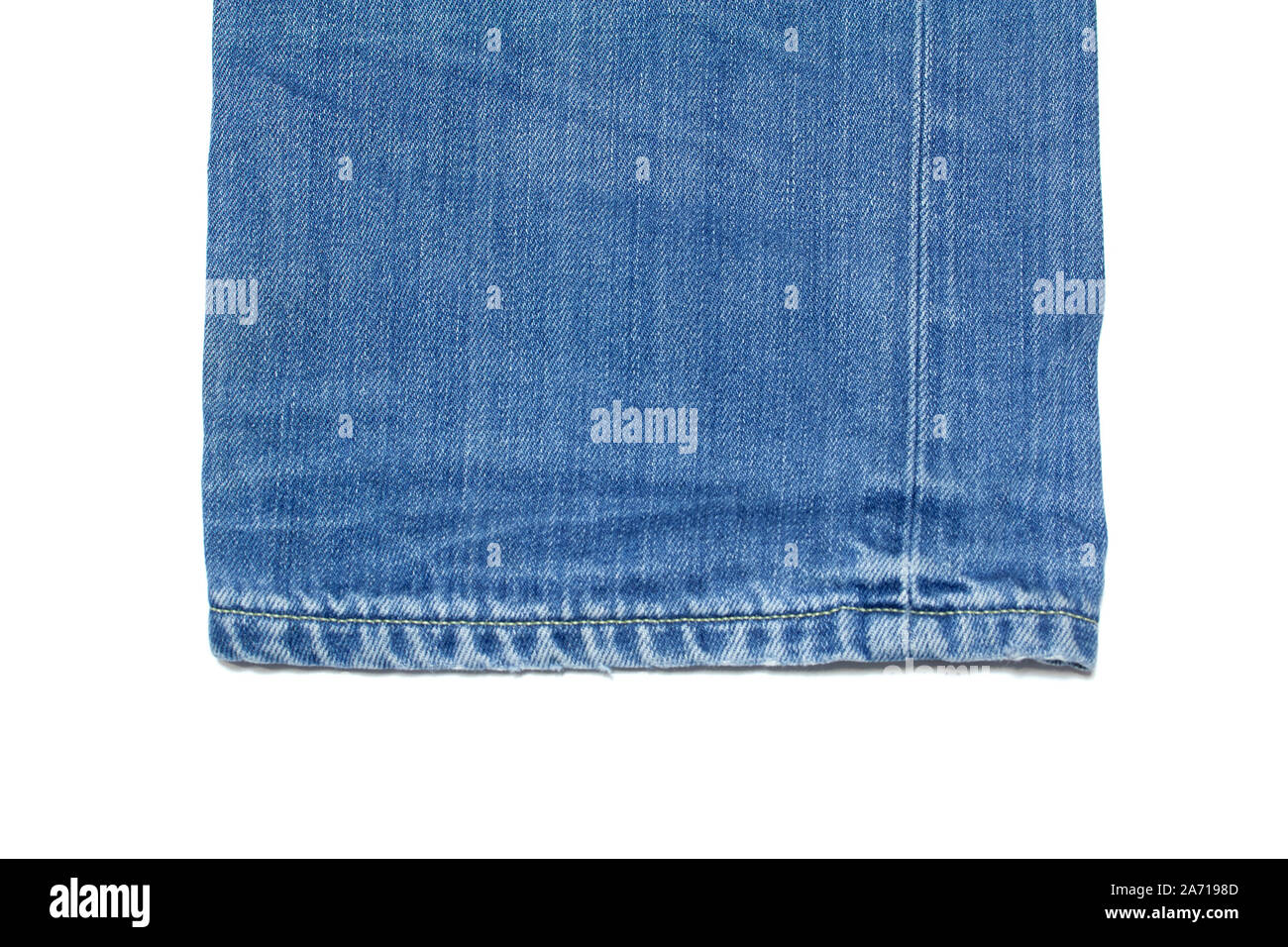Trouser leg of blue jeans on a white background Stock Photo - Alamy