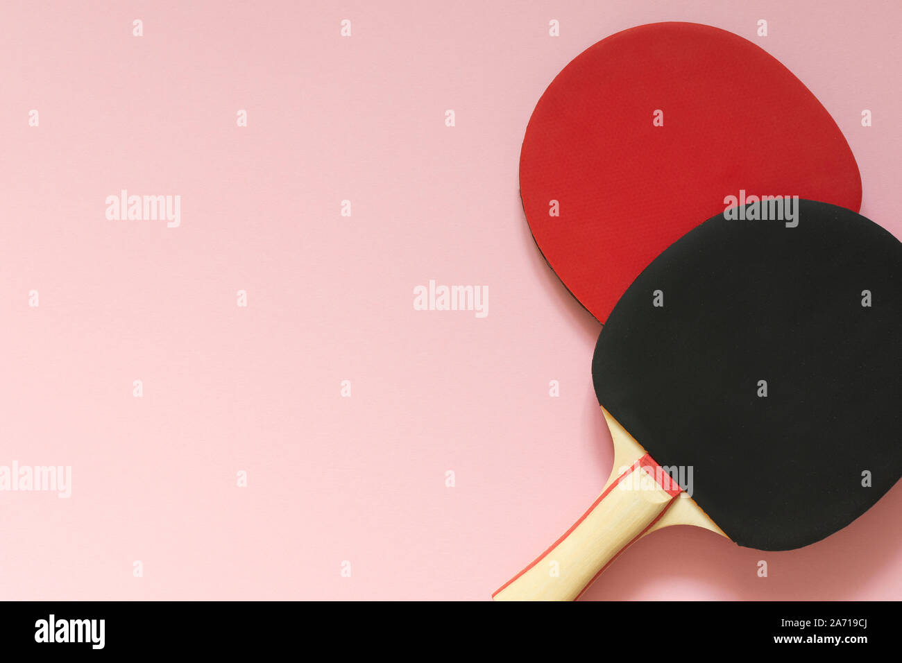 Black and red tennis ping pong rackets isolated on a pink background ...