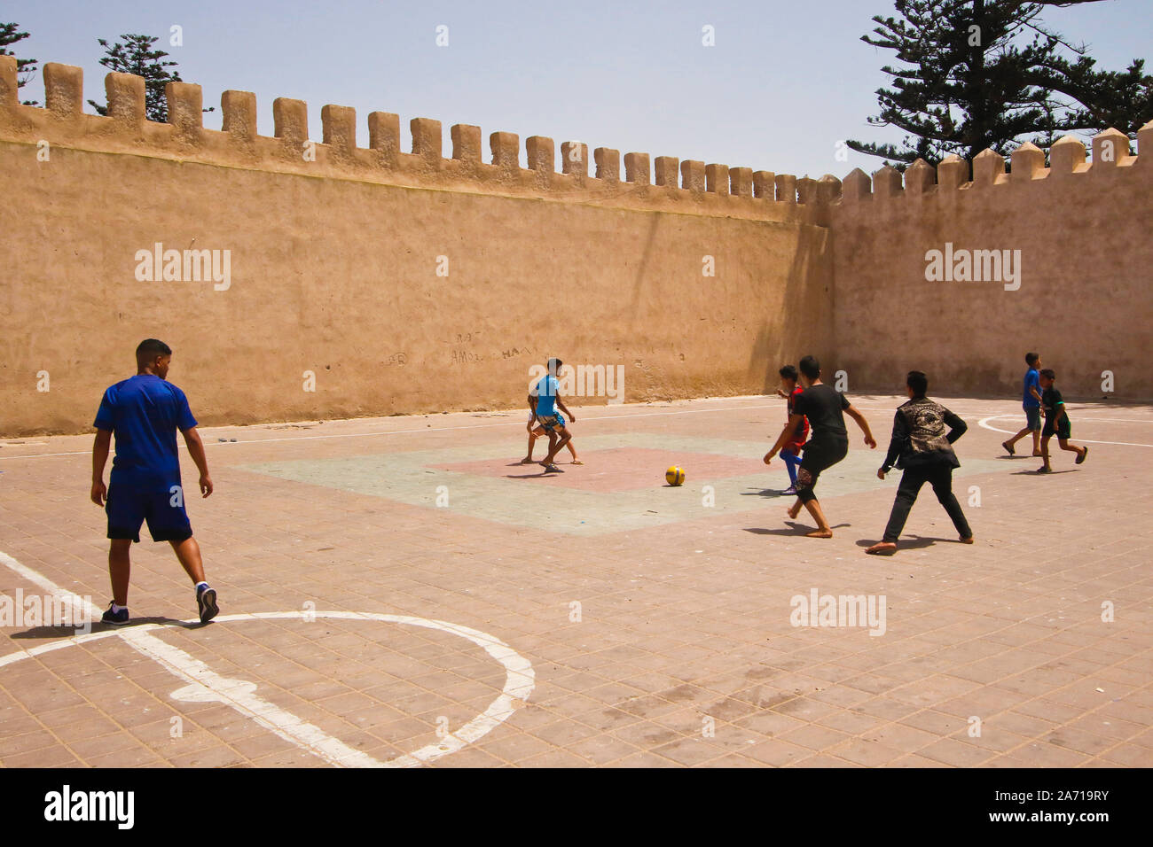 Boys playing soccer in street hi-res stock photography and images - Alamy