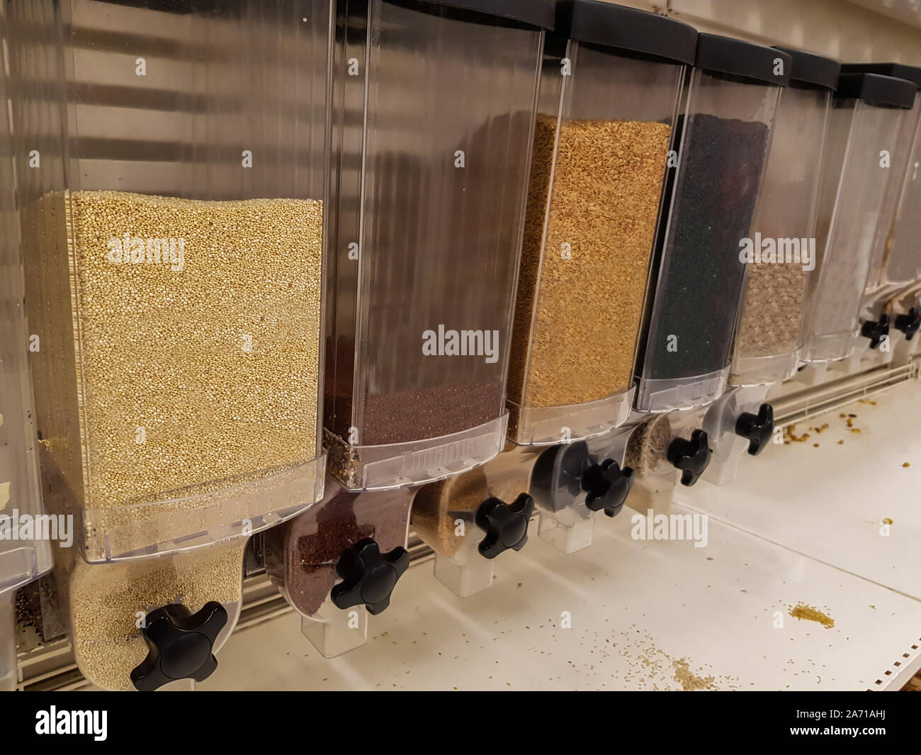 Row of food dispensers with seeds at grocery store Stock Photo - Alamy