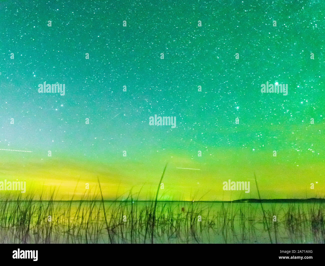 landscape with a beautiful colorful night sky and stars, reflection on ...