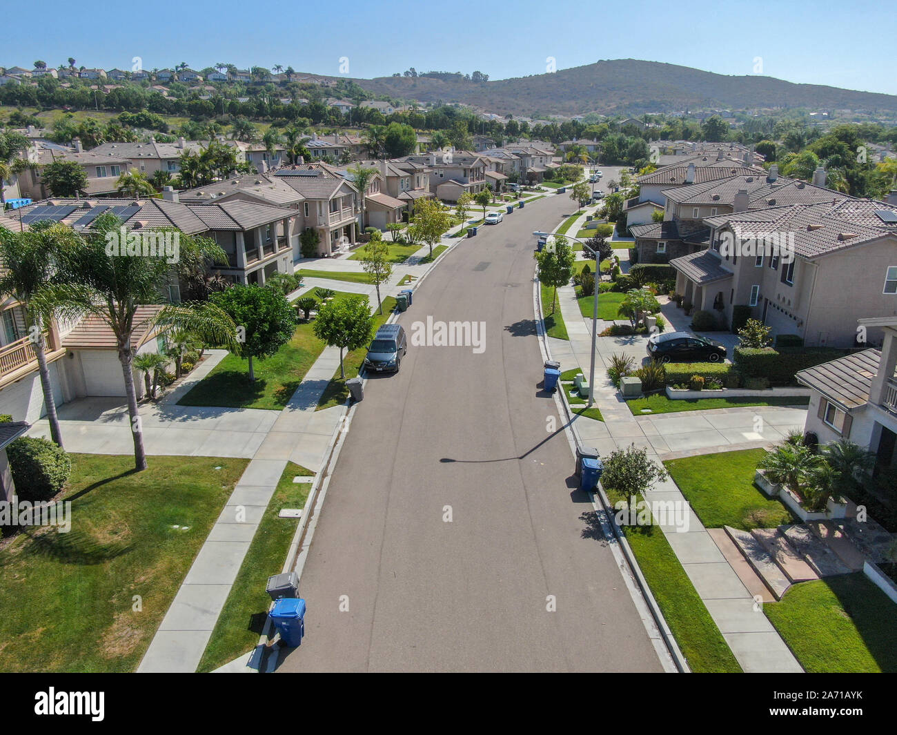 Suburban neighborhood street with big villas next to each other in ...