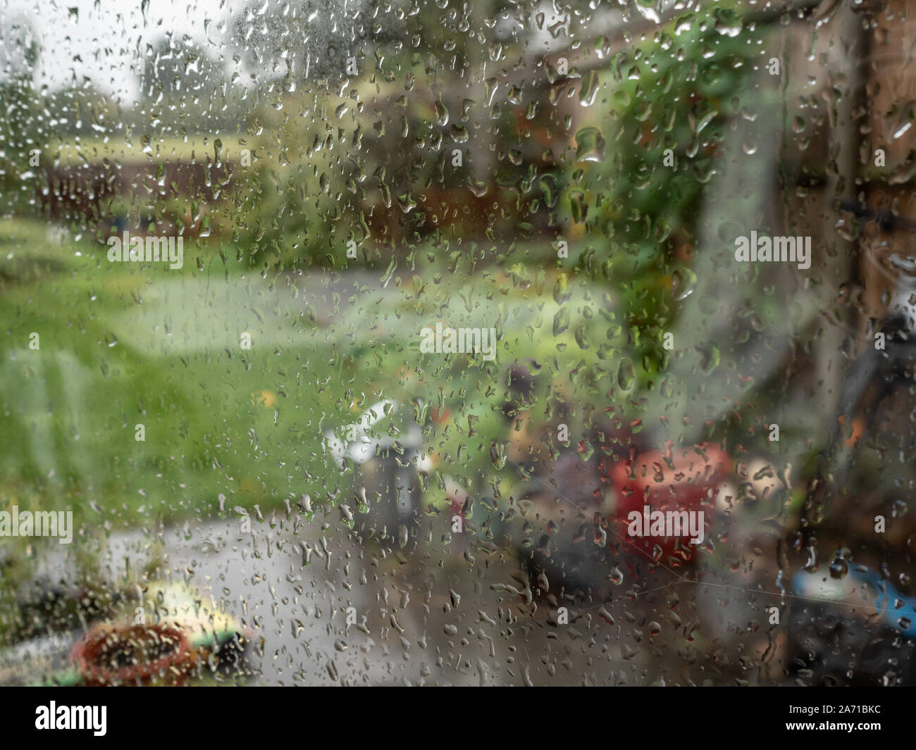 Autumn garden seen through rain splattered window Stock Photo - Alamy