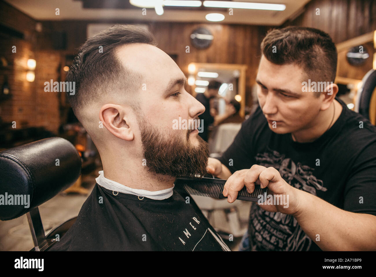 Barber shop, a man with a beard cut hairdresser. Professional haircut ...