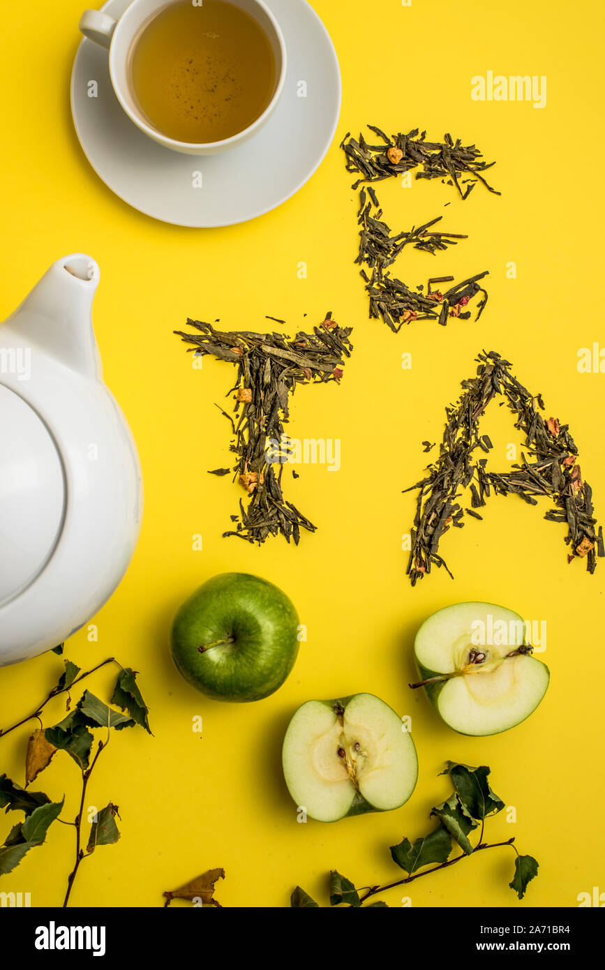 Tea inscription made from tea leaves. Yellow background. Tea cup and ...