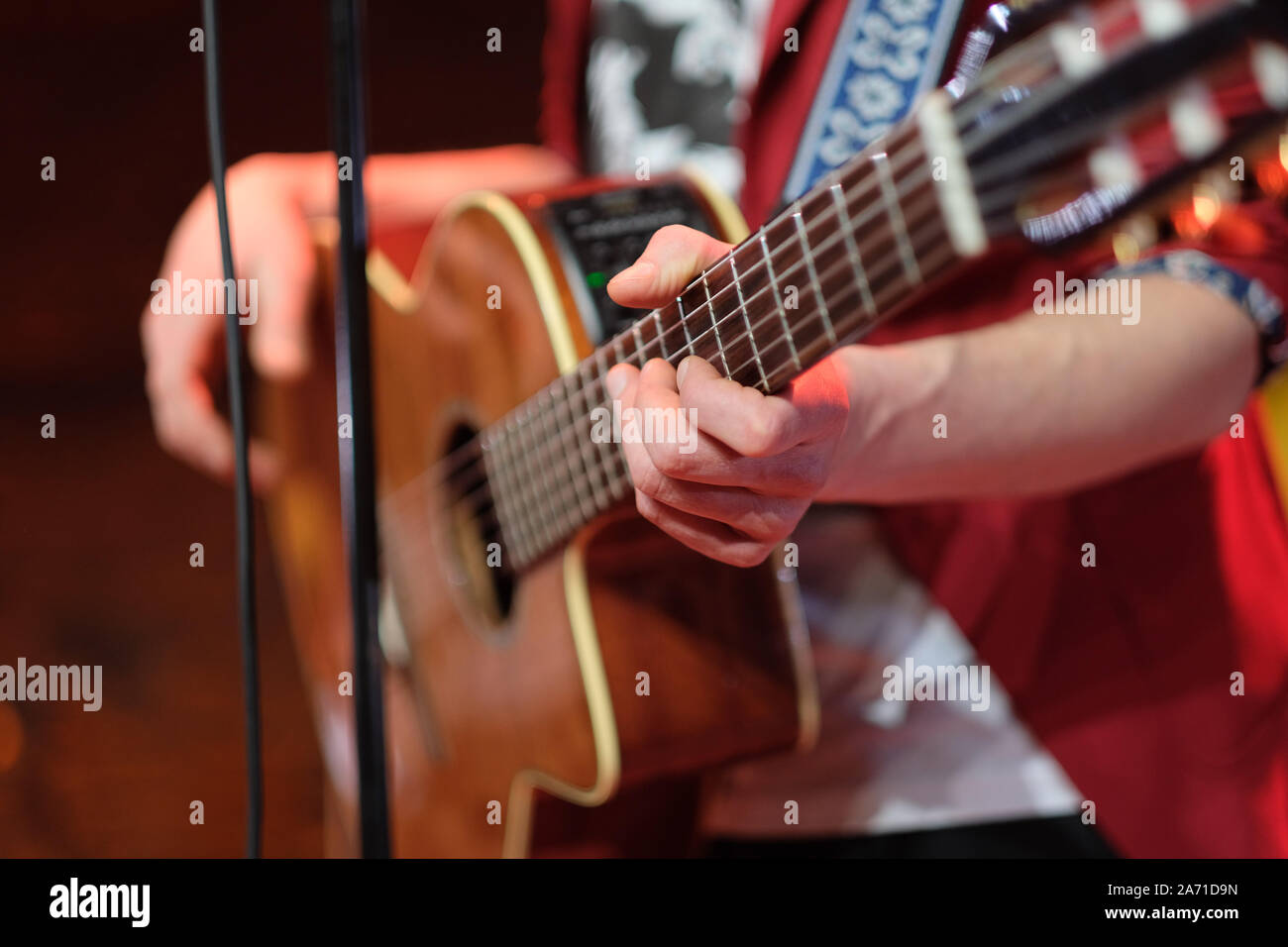 Six string acoustic giant guitar in the hands of a musician Stock Photo ...