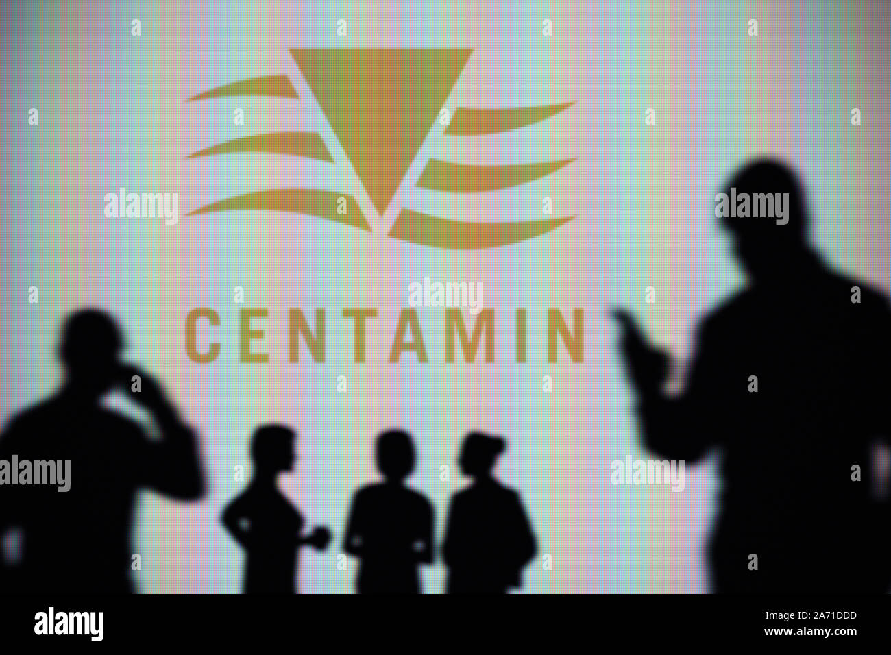 The Centamin logo is seen on an LED screen in the background while a ...
