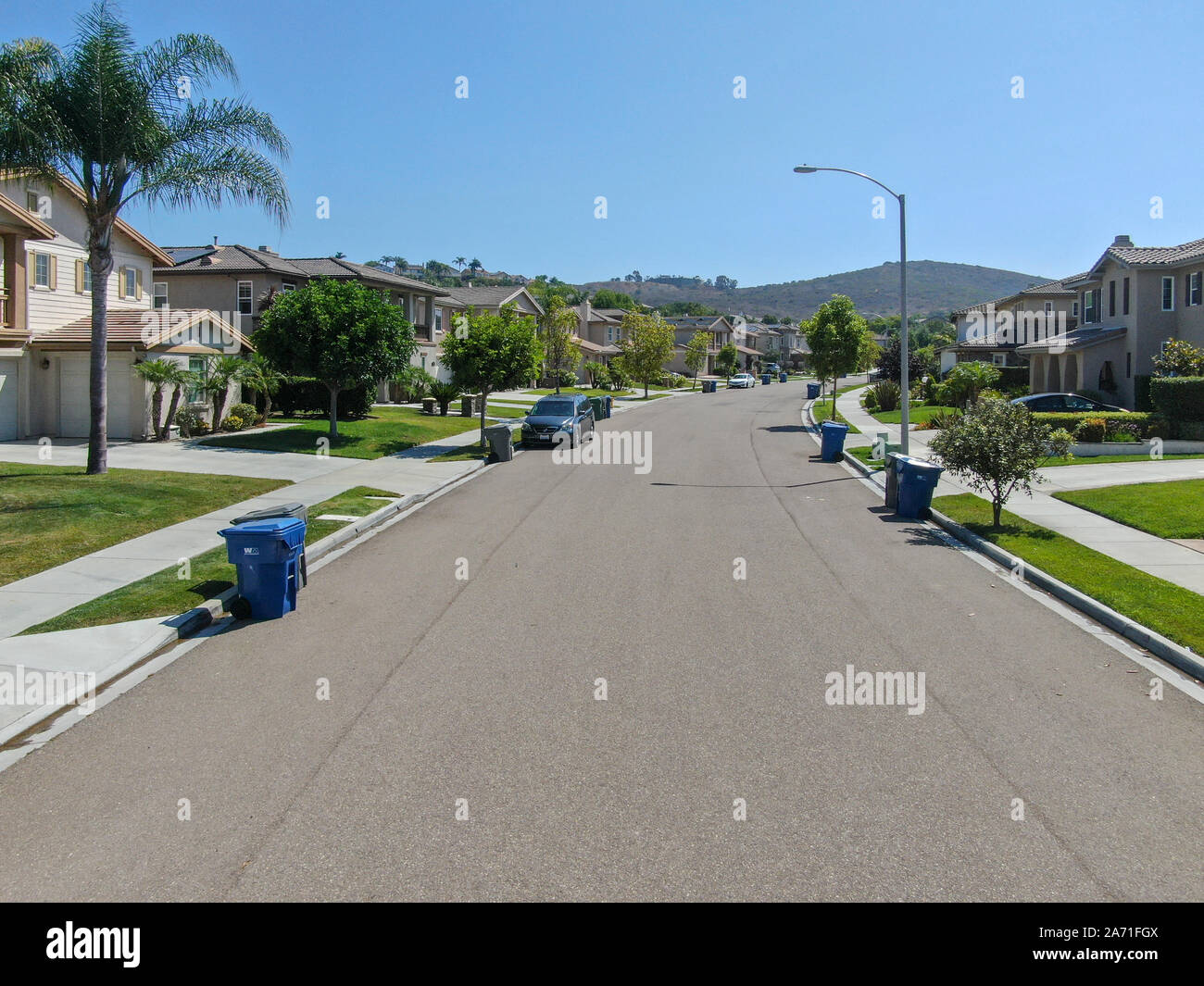 Suburban neighborhood street with big villas next to each other in ...