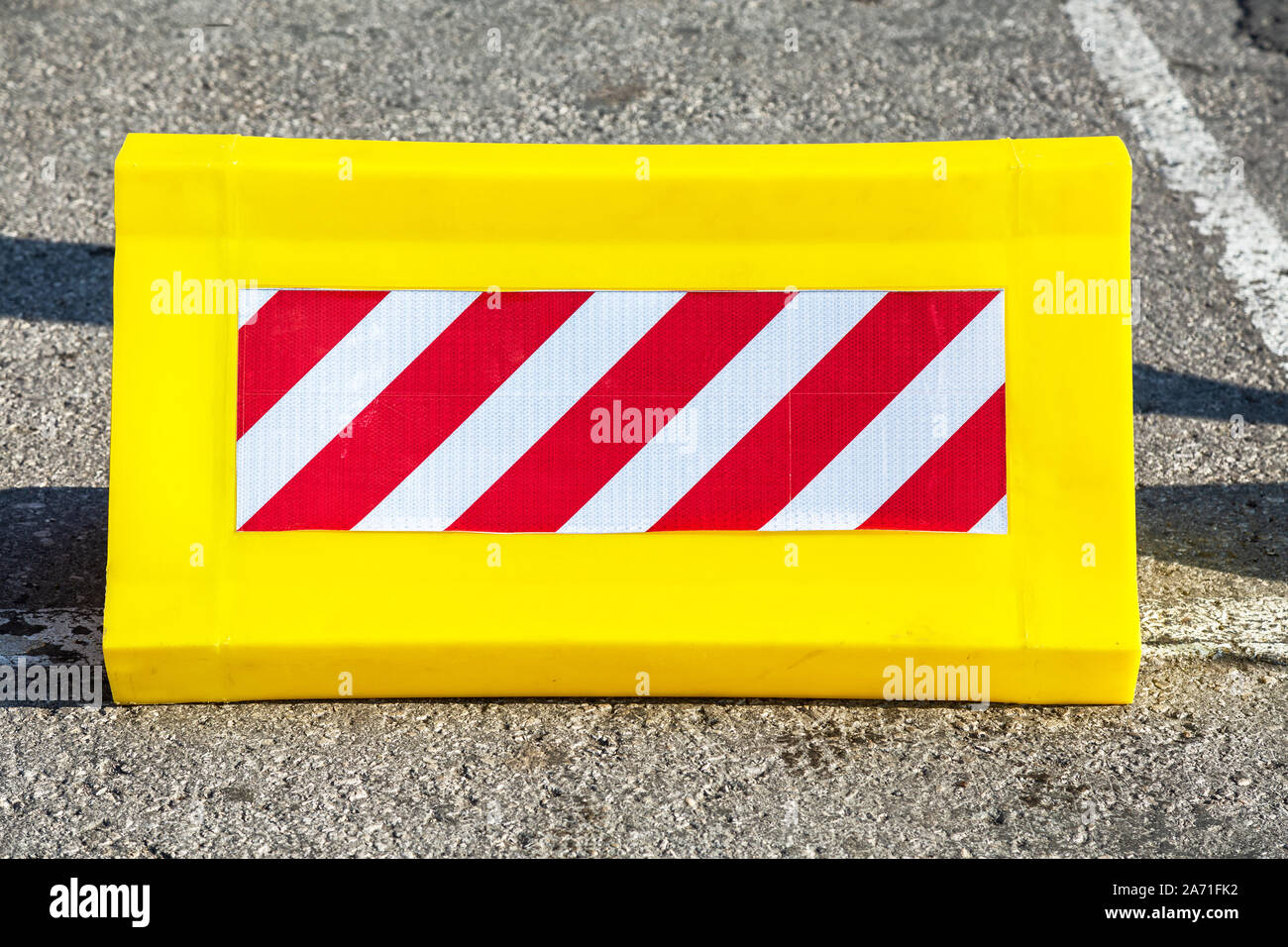 Road barrier with red and white striped caution pattern, road fence at ...