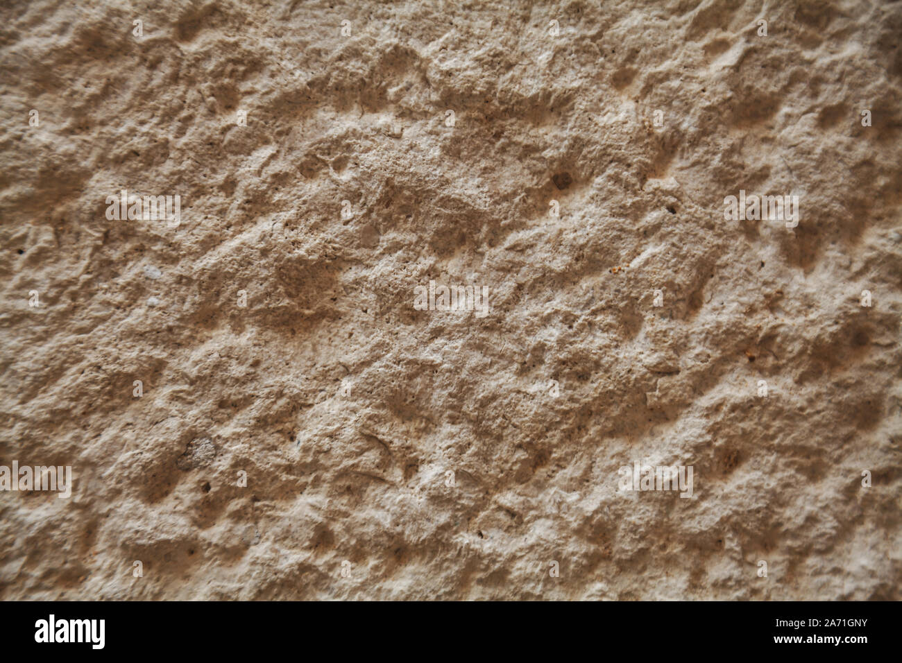 Wavy stone wall texture in soft sunlight Stock Photo - Alamy