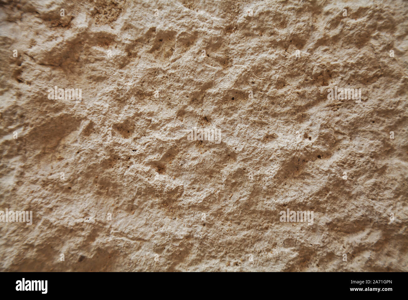 Wavy stone wall texture in soft sunlight Stock Photo - Alamy