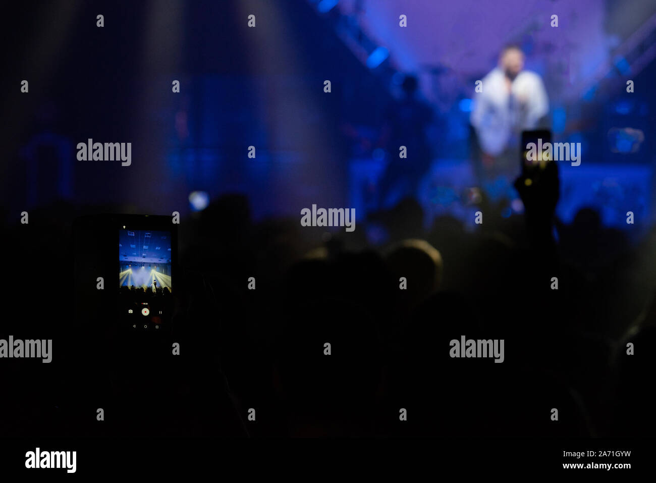 Person on stage holding phone hi-res stock photography and images - Alamy
