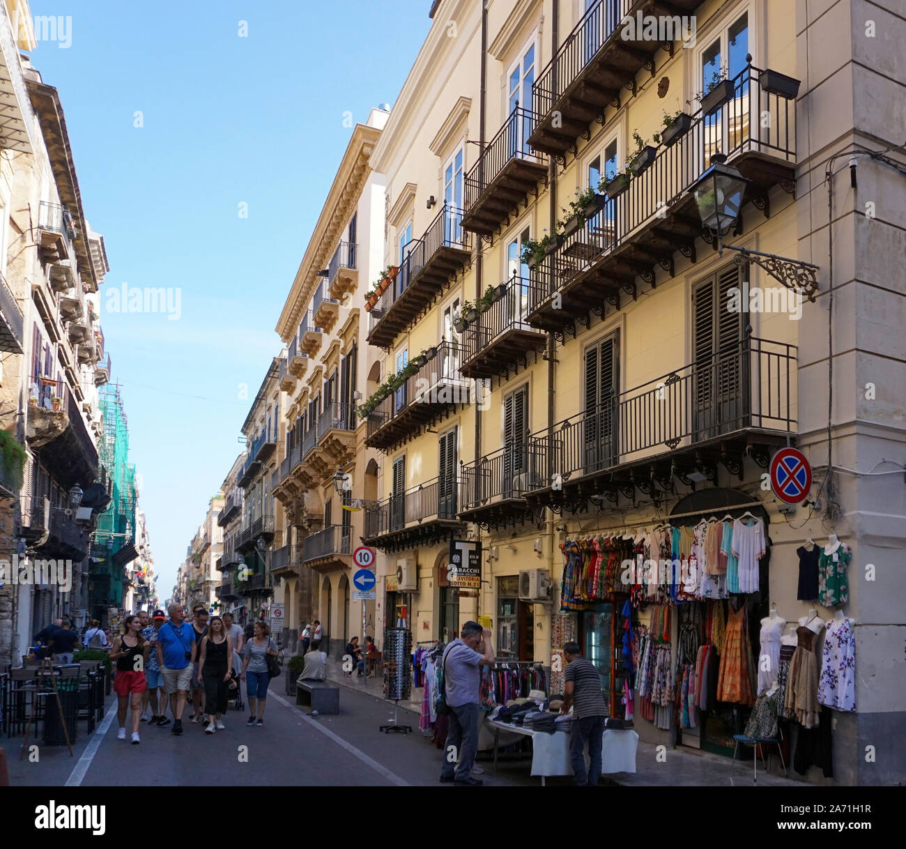 A typical Palermo street scene with a tour group passing, street food ...