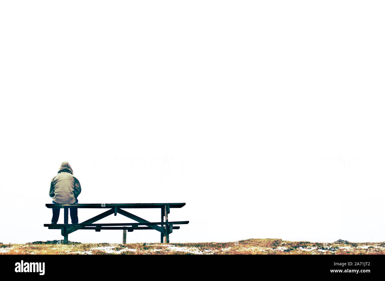 Lonely man sitting on a bench in winter Stock Photo - Alamy