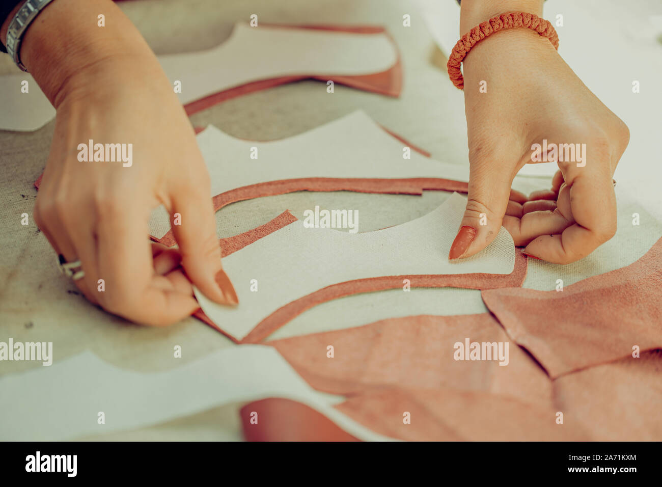 Hands of an experienced worker in the handmade footwear industry ...