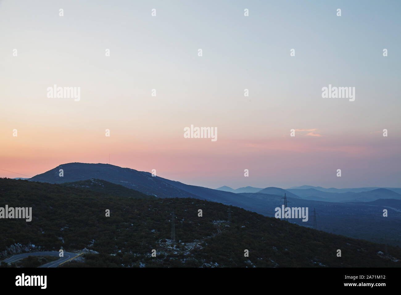 Spectacular view from top of high hills layered with mist after sunset ...