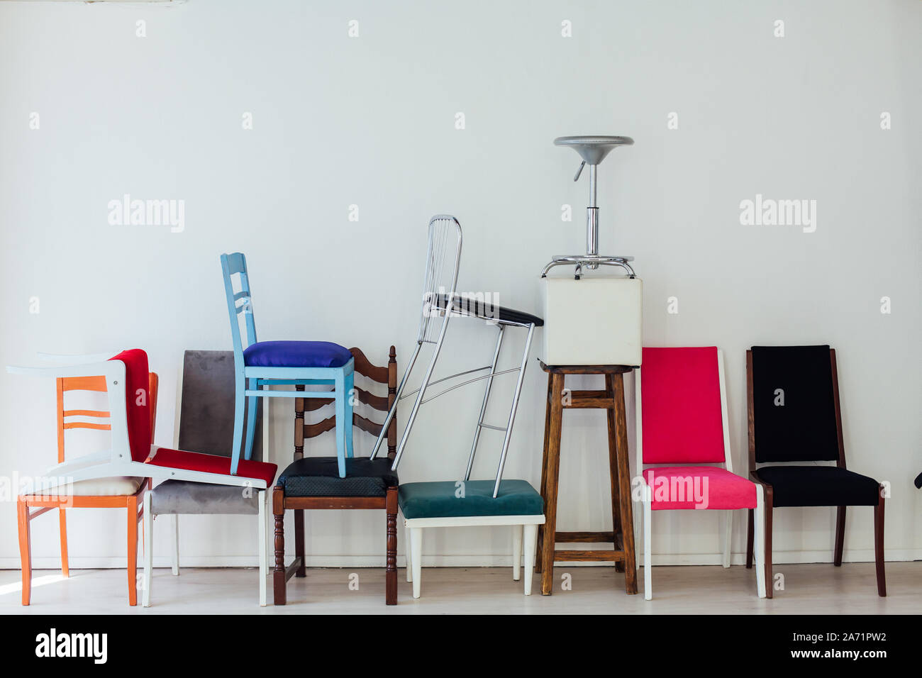 different multicolored chairs in the interior of the white room Stock ...
