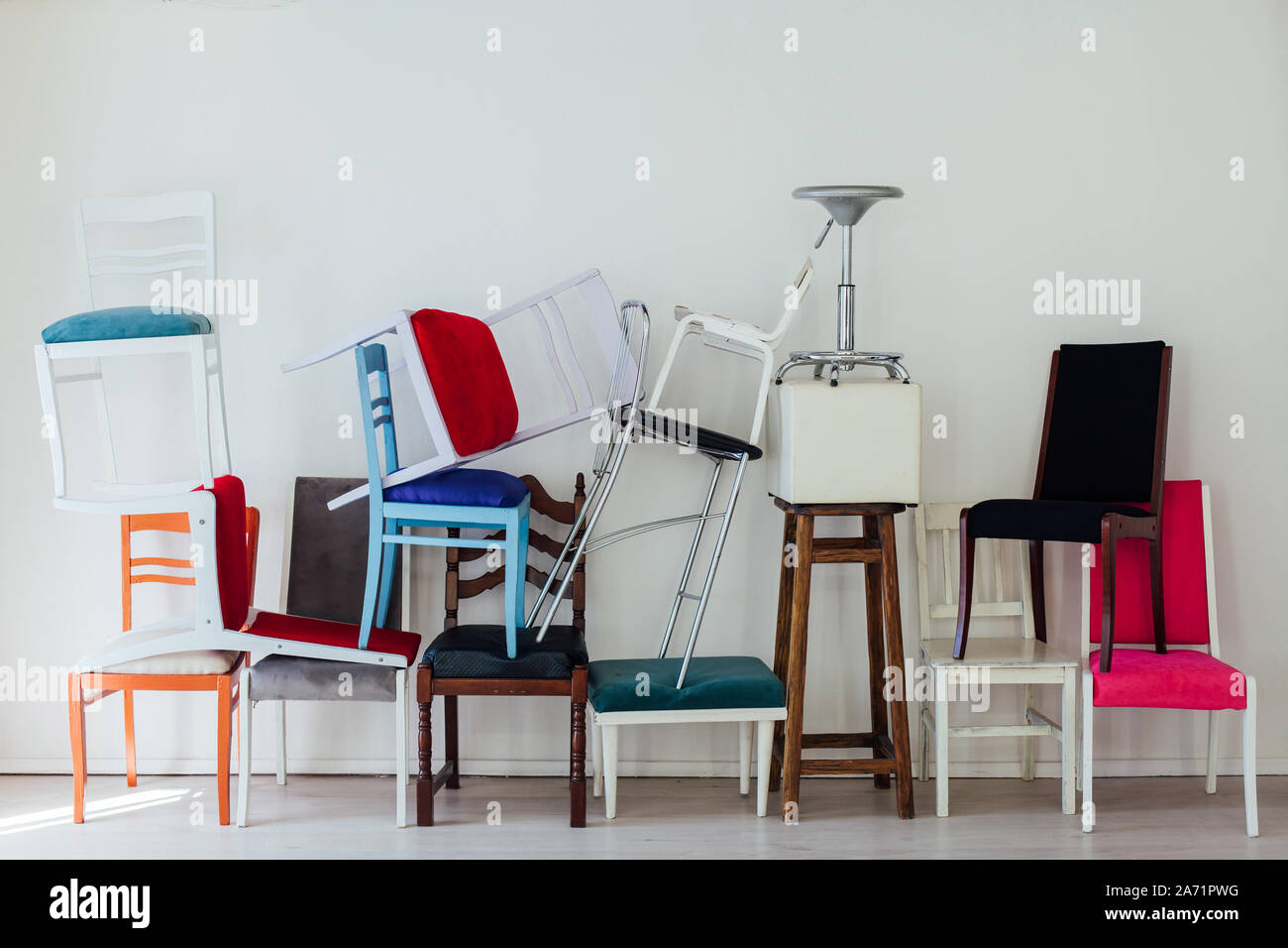 different multicolored chairs in the interior of the white room Stock ...