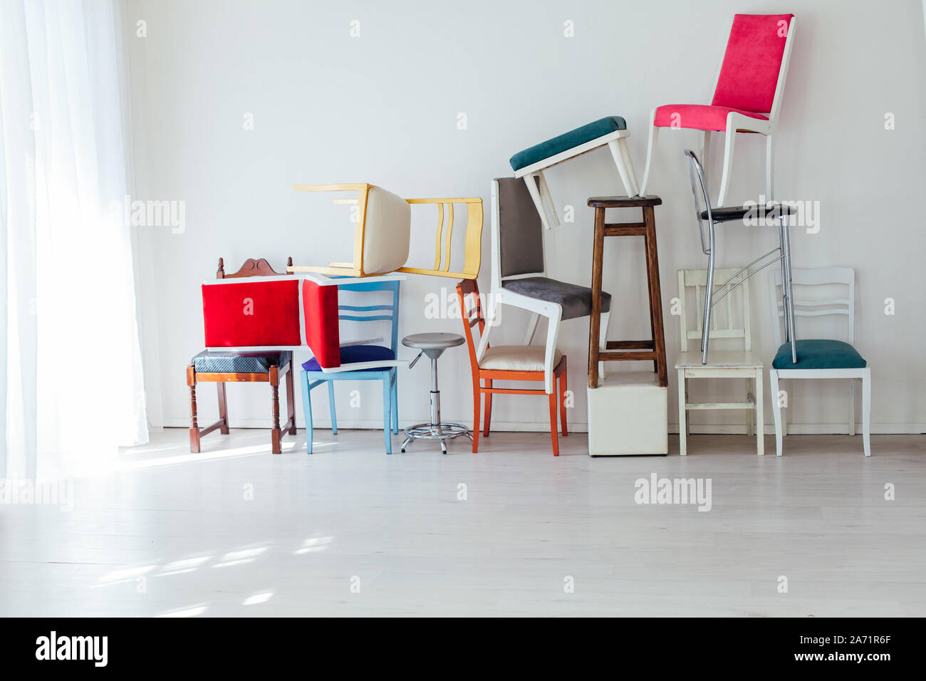 different multicolored chairs in the interior of the white room Stock ...