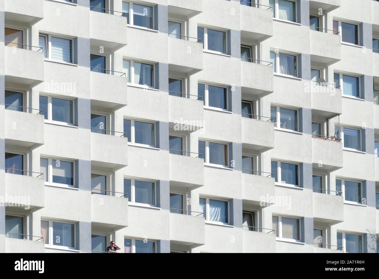 Monotonous house facade with balconies on a white residential house hi ...