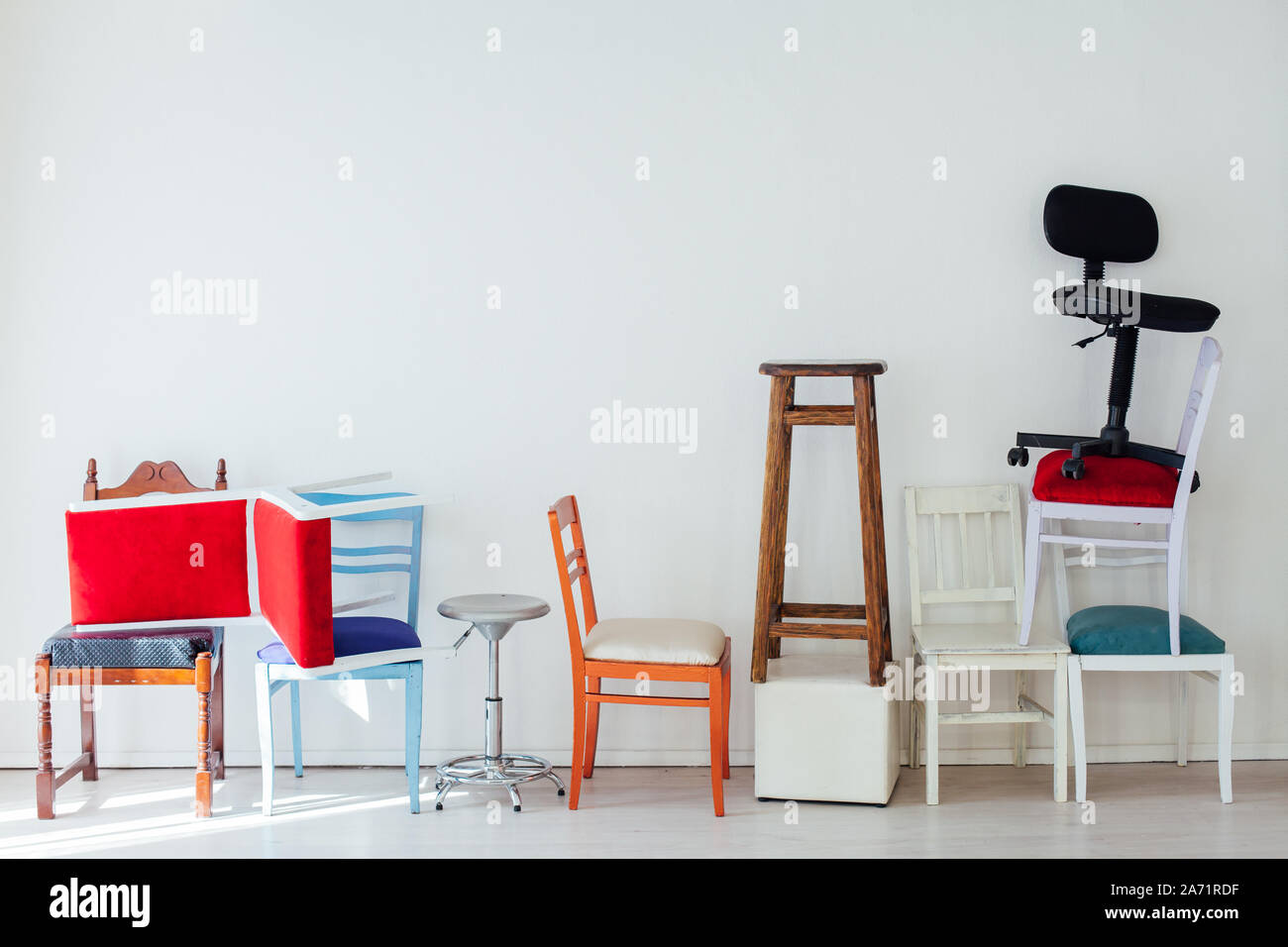 different multicolored chairs in the interior of the white room Stock ...