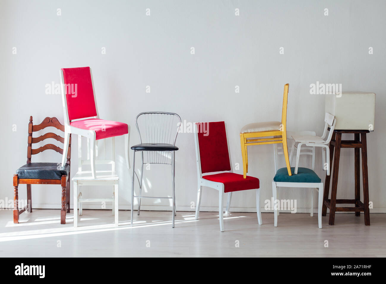 different multicolored chairs in the interior of the white room Stock ...