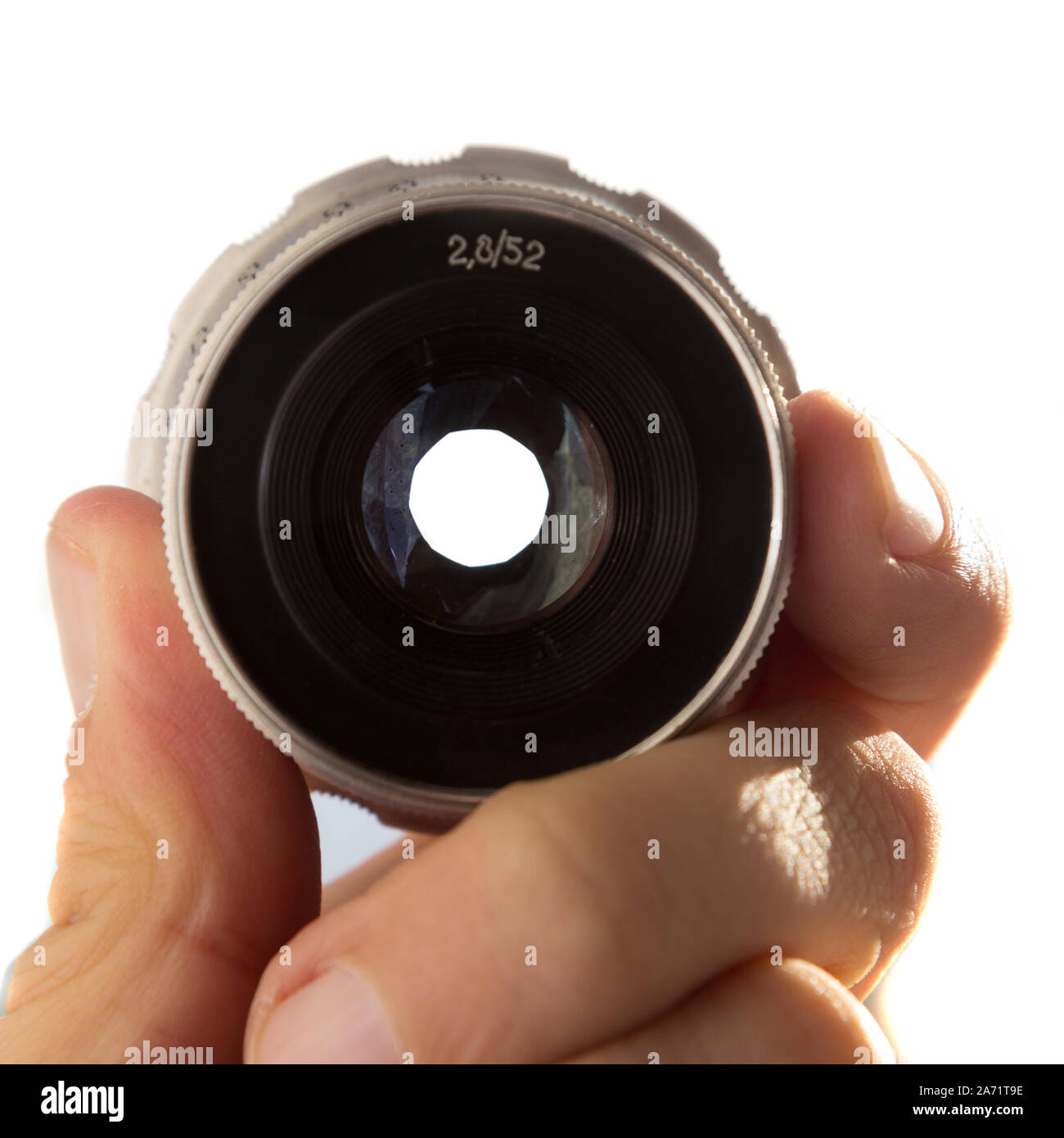 Hand holding camera lens on white background Stock Photo - Alamy