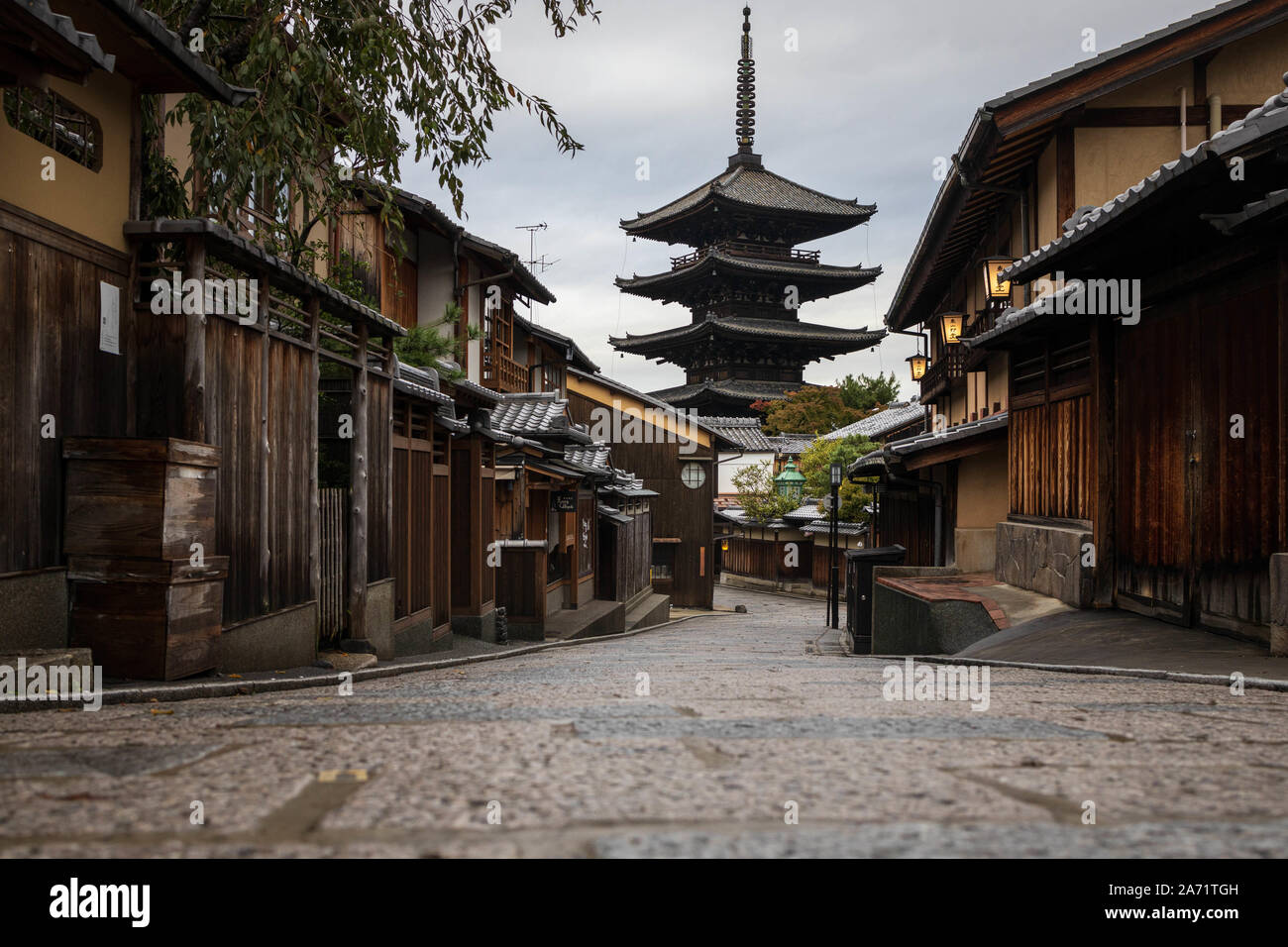 Narrow street through traditional Japanese wooden buildings leading to ...