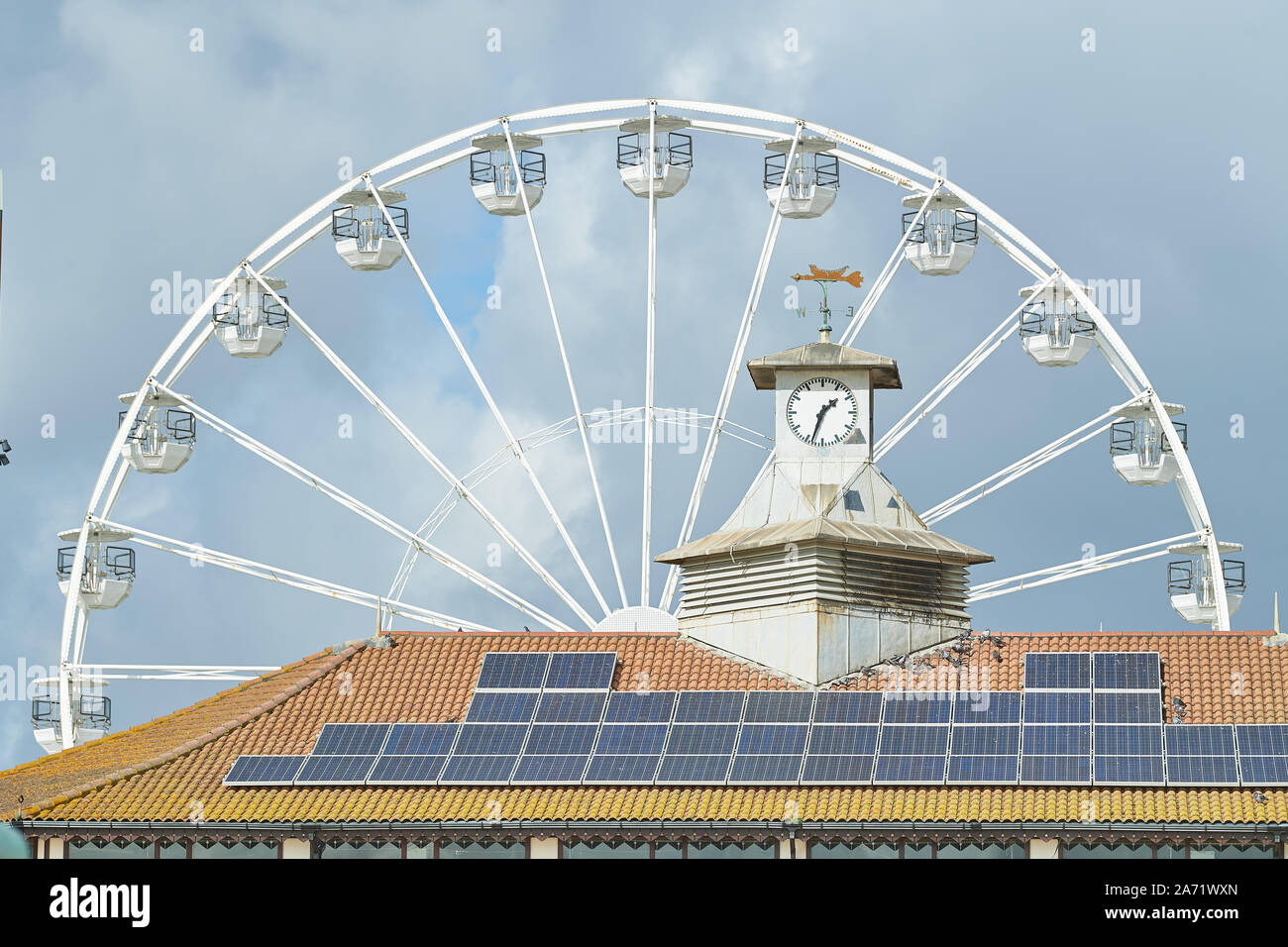 The ferrris wheel behind the clock tower of the pier at Bournemouth ...