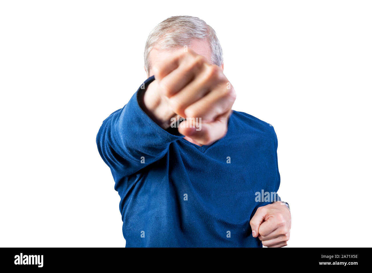 An elderly man demonstrates fist fight. Isolated on a white background ...