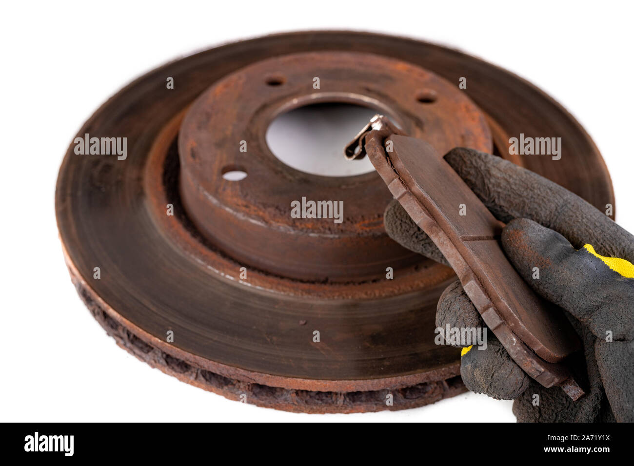 Old rusty brake disc and worn block. Used spare parts for passenger ...