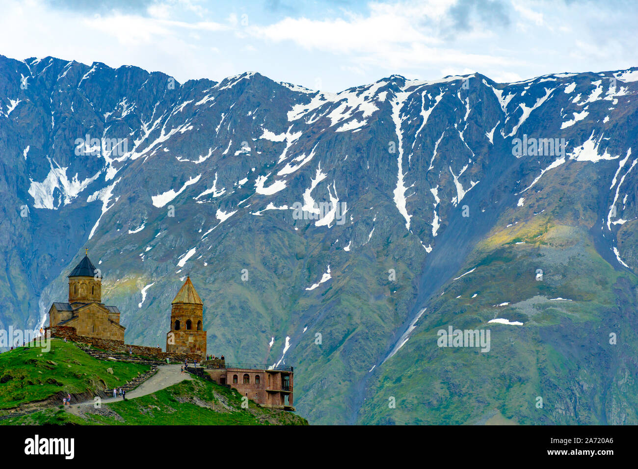 Gergeti Trinity Church also known as Tsminda Sameba on the background ...