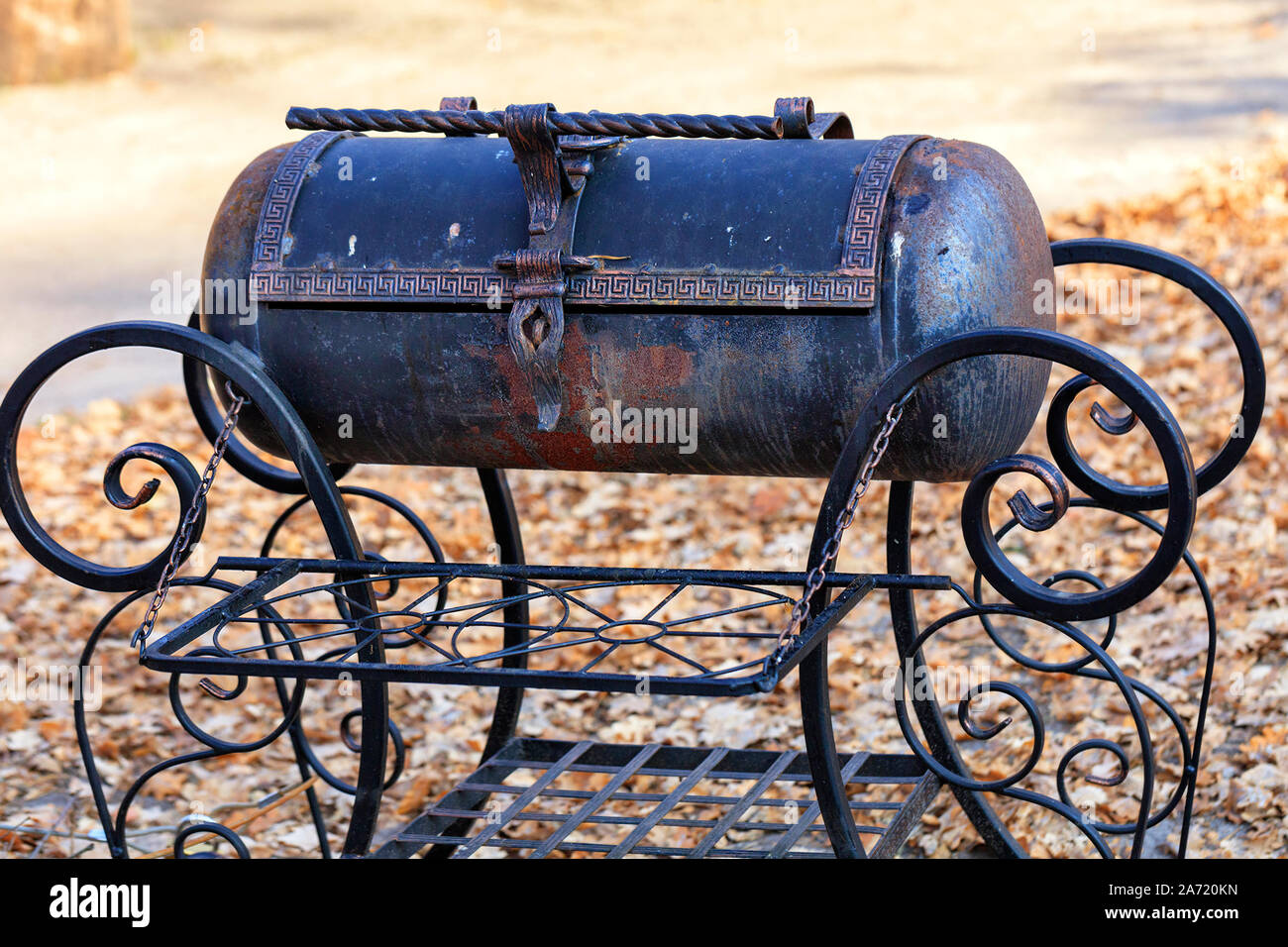 Metal grill with twisted wrought iron curly handles Stock Photo - Alamy