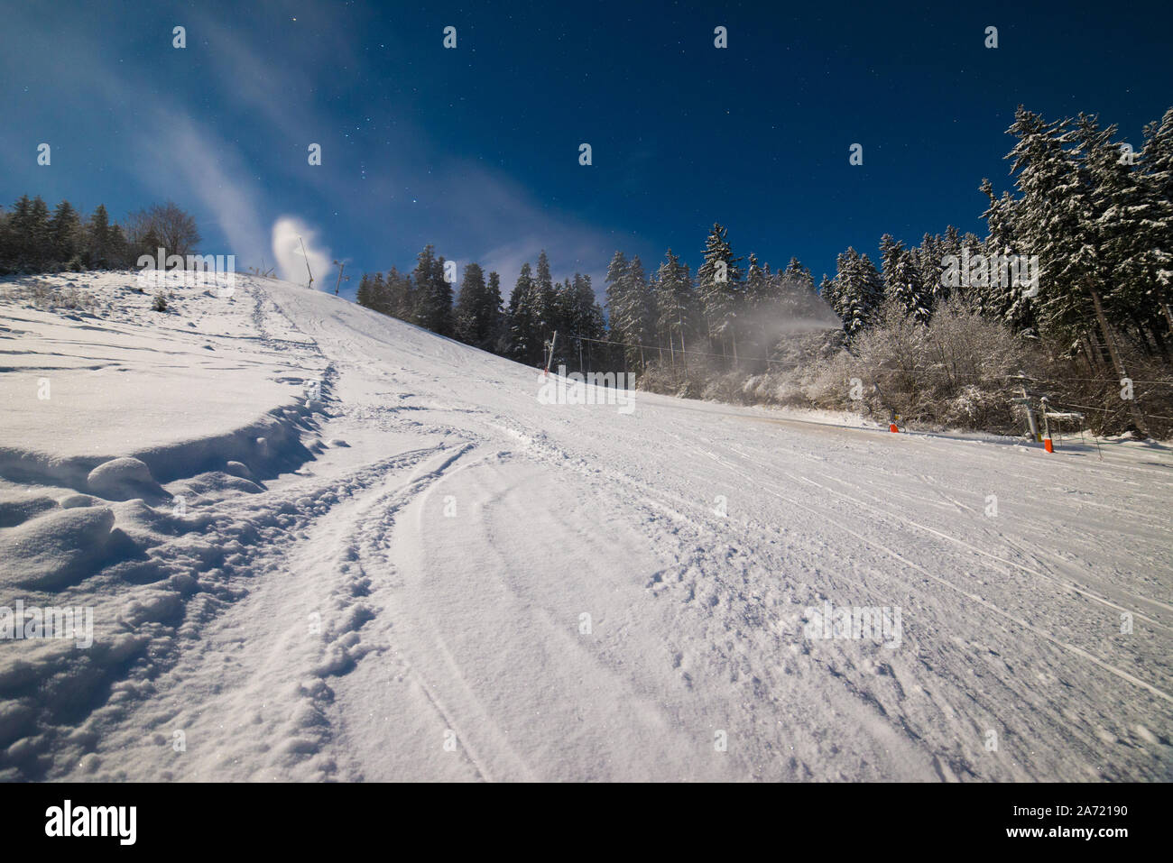 Snow blowers working at night on the slope Stock Photo - Alamy