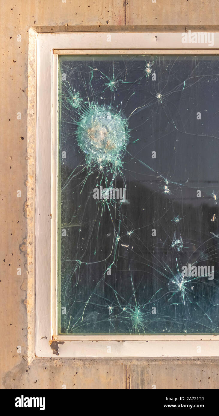 Vertical frame Bullet holes in the window glass of a bulletproof bunker ...