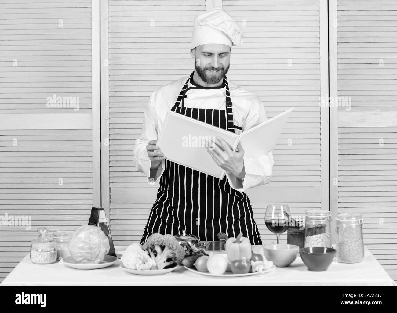 Guy read book recipes. Culinary arts concept. Man learn recipe. Improve ...