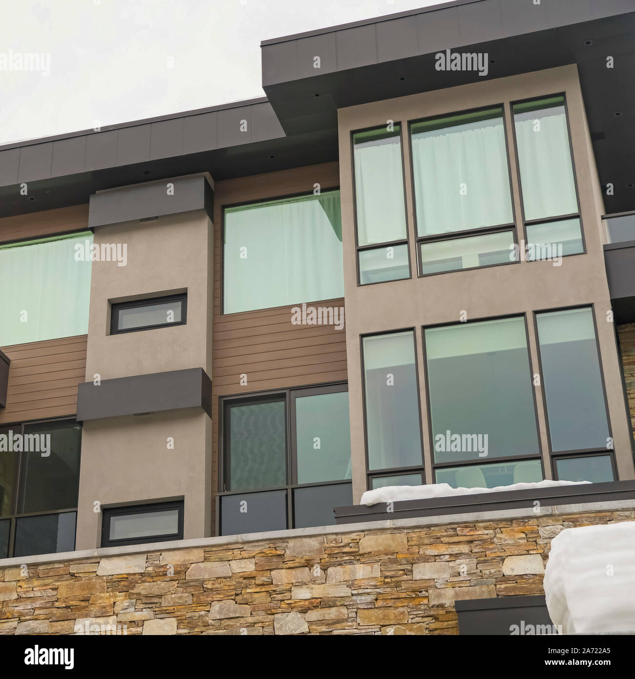 Square Exterior of a modern home with flat rooftop large windows and ...