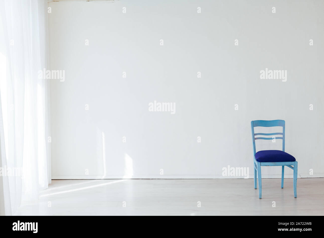 one chair in the interior of an empty white room Stock Photo - Alamy