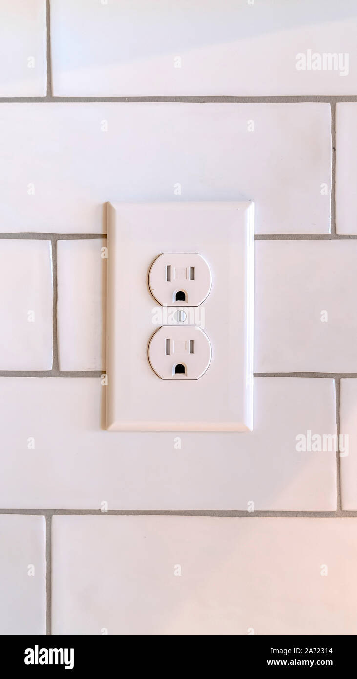 Vertical Power outlet on white wall in home Stock Photo - Alamy