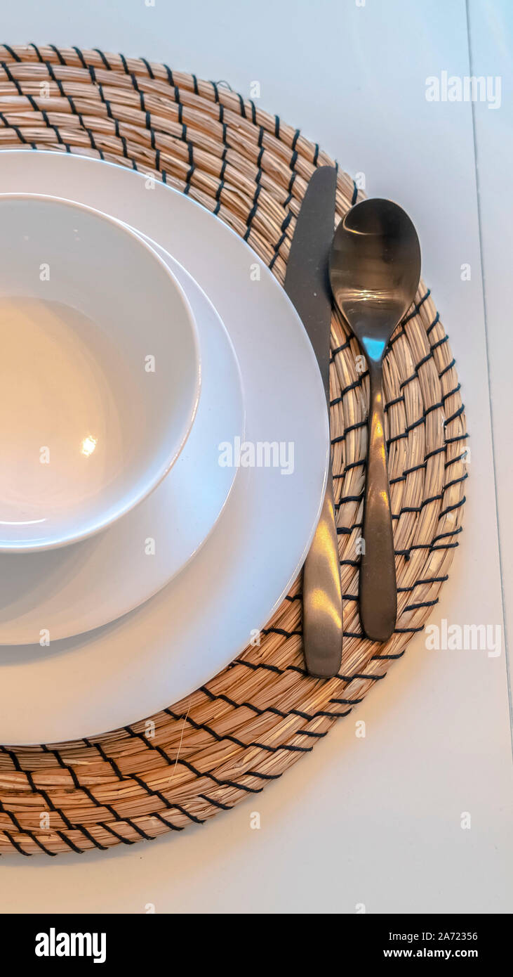 Vertical Dinner table setting with cutlery and crockery Stock Photo - Alamy