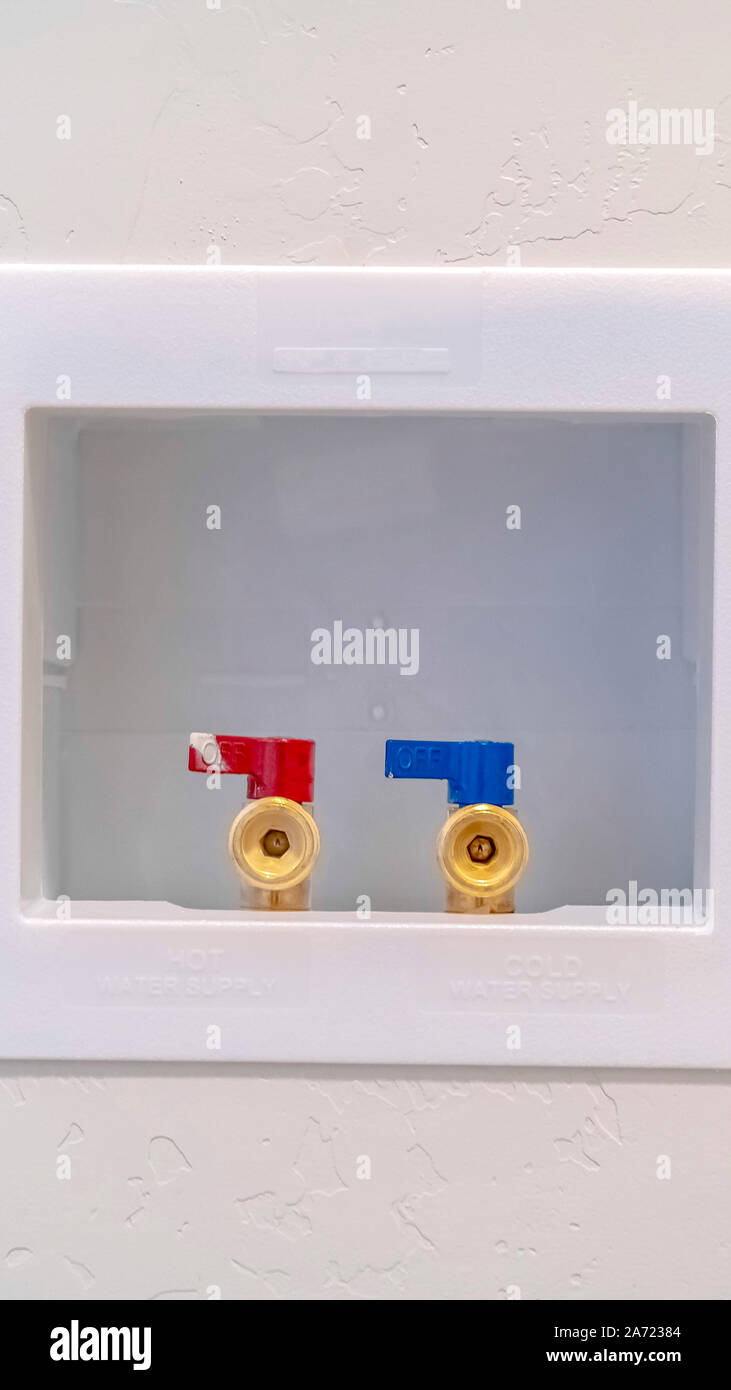Vertical Close up of hot and cold water laundry connection Stock Photo ...
