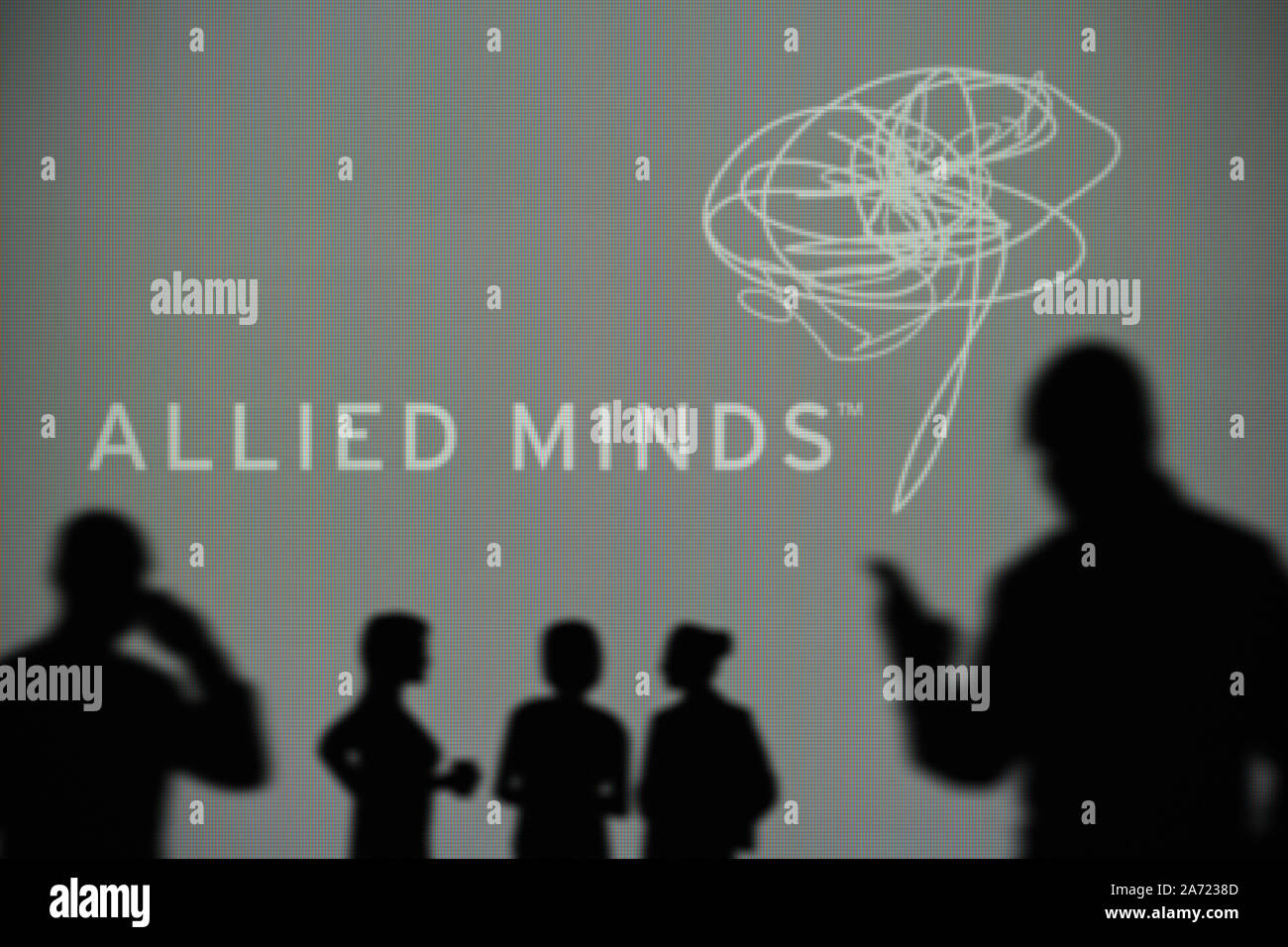 The Allied Minds logo is seen on an LED screen in the background while ...