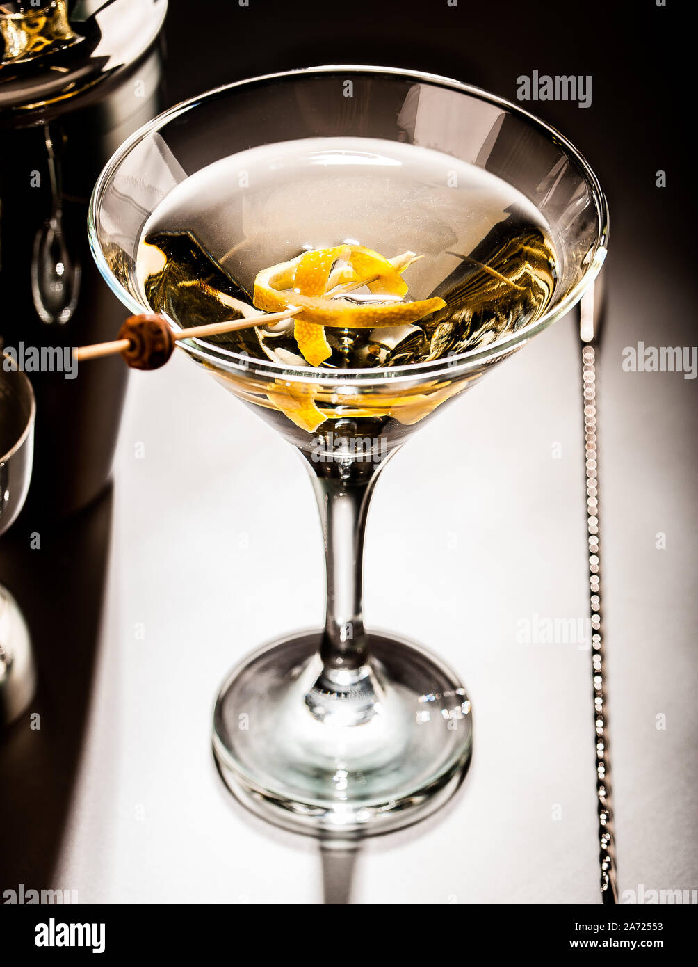 A glass of martini with a lemon twist Stock Photo - Alamy