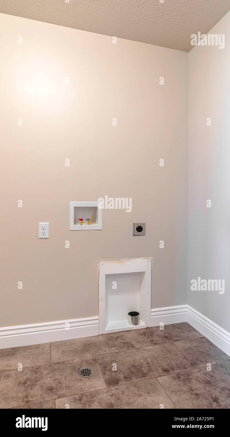 Vertical Empty laundry room with water connections empty room Stock ...