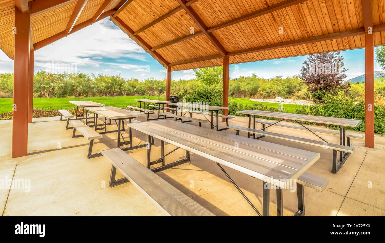Panorama frame Close up view inside the pavilion of a park with tables ...