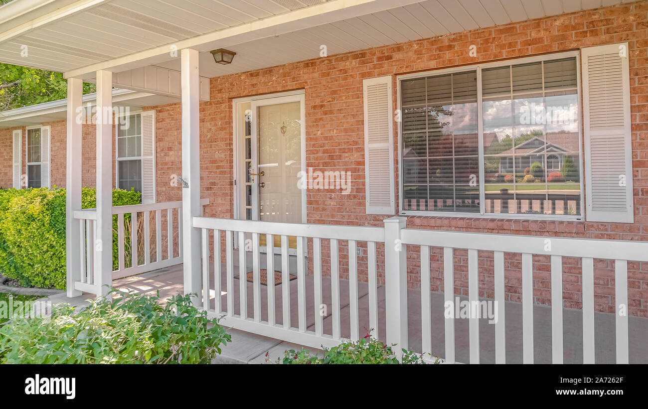 Panorama frame Front porch and garden of traditional brick home Stock ...