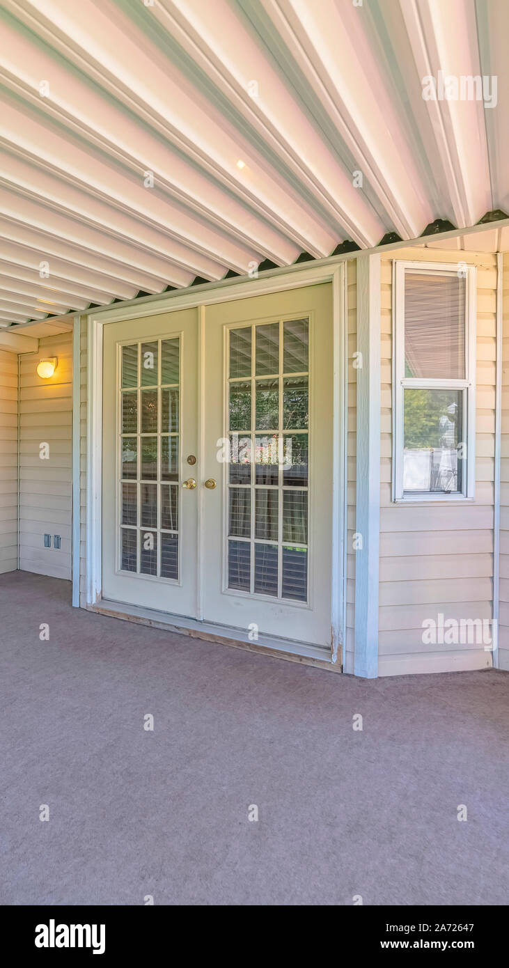 Vertical Veranda area of traditional home with covered spa Stock Photo ...